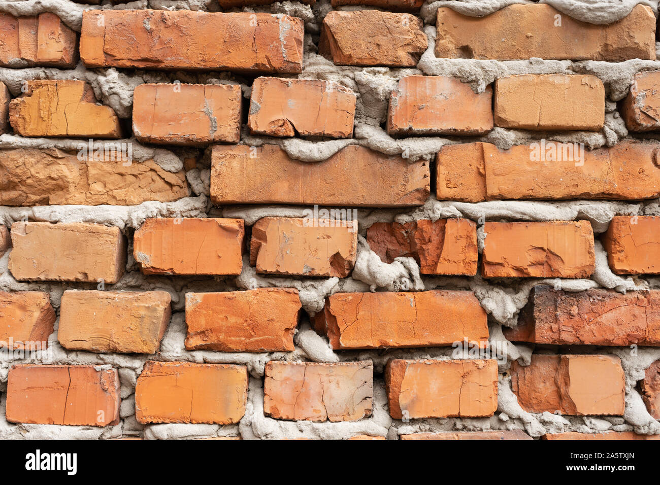 old red brick falling apart wall texture background Stock Photo - Alamy