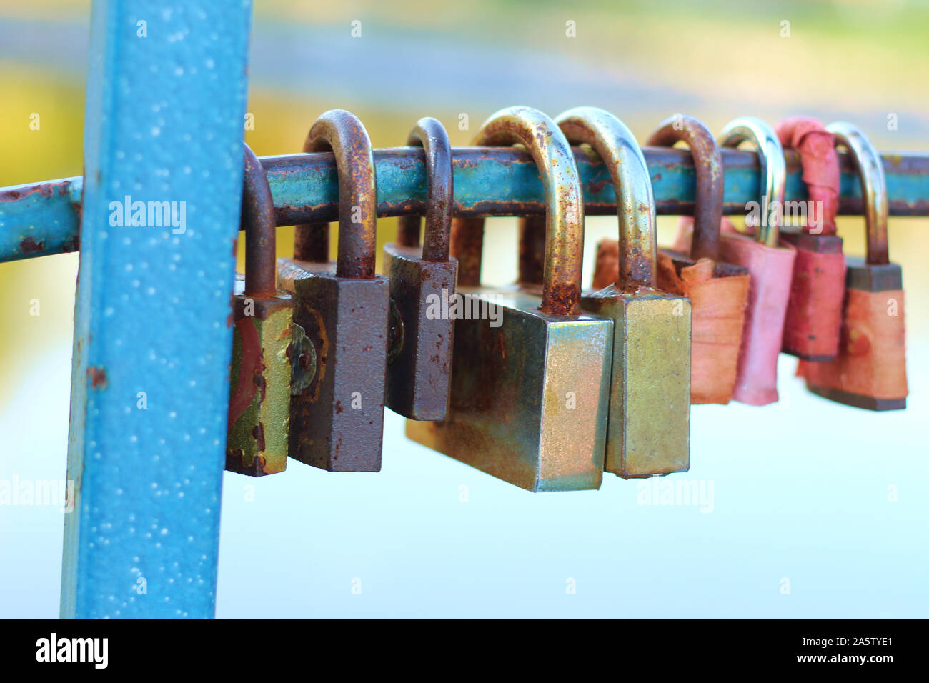 colored padlocks on the railing of the bridge over the river Stock ...