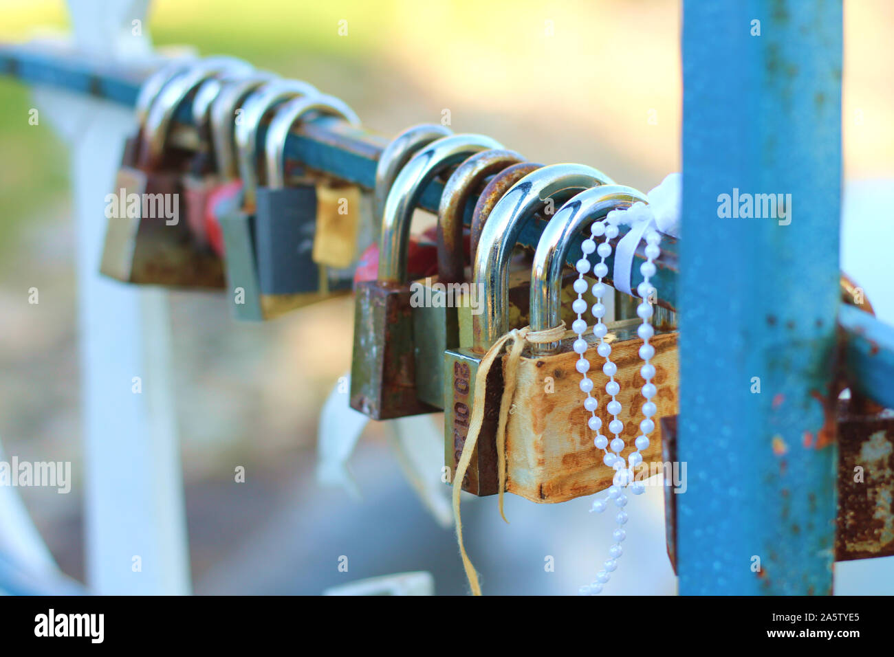 colored padlocks on the railing of the bridge over the river Stock ...