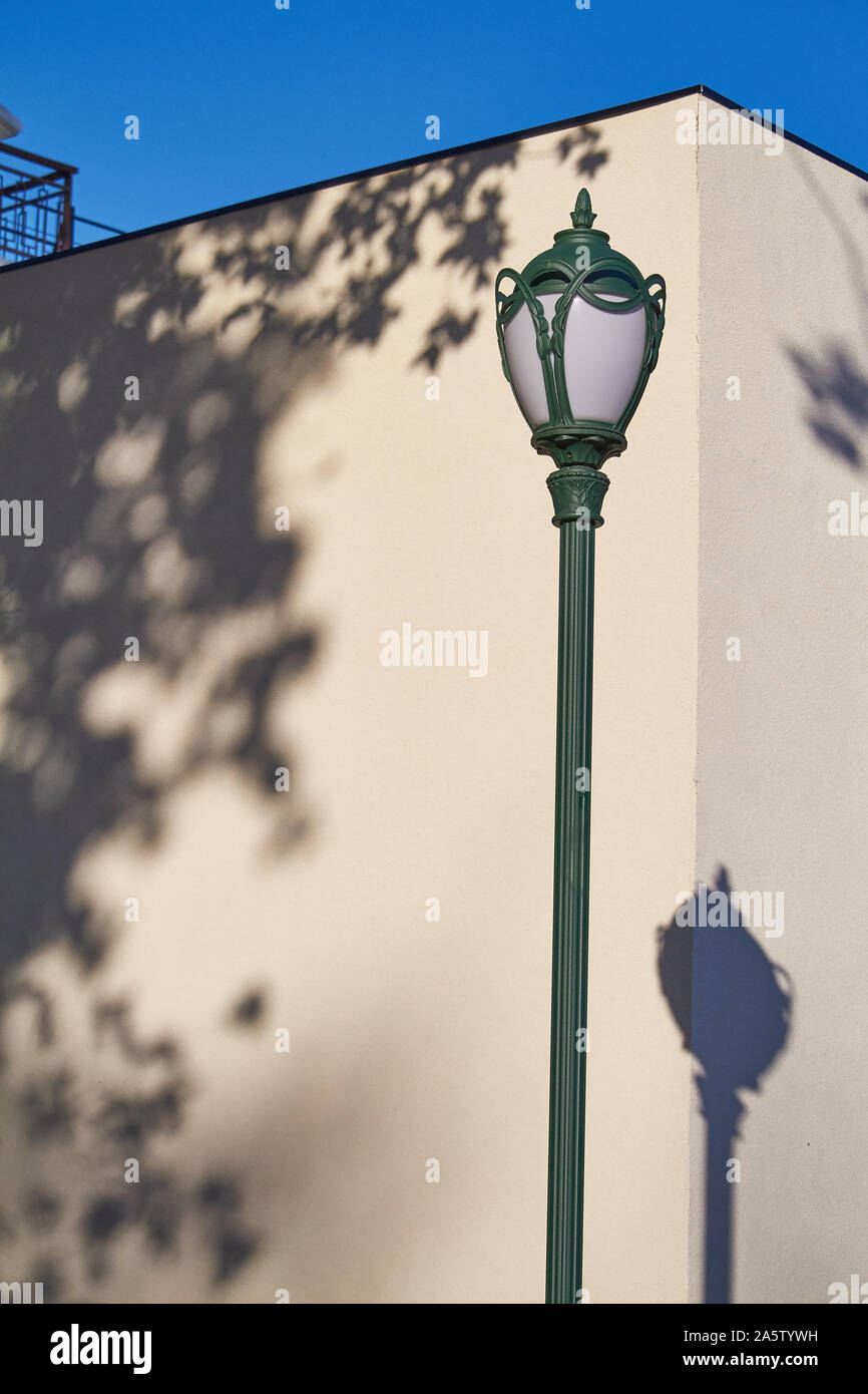 Street lamp and its shadow on white wall background Stock Photo - Alamy