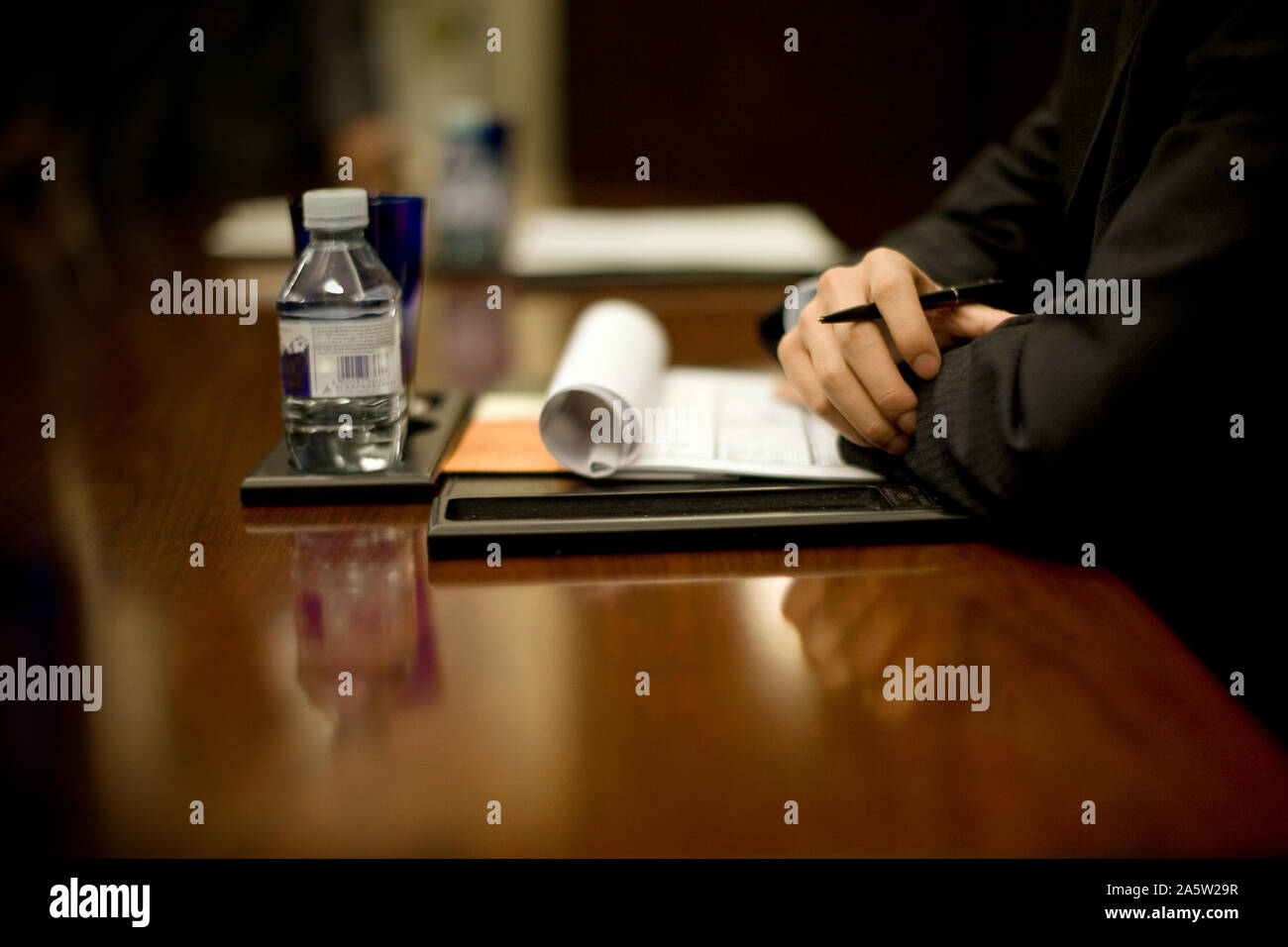Notes being taken by people in a boardroom Stock Photo - Alamy