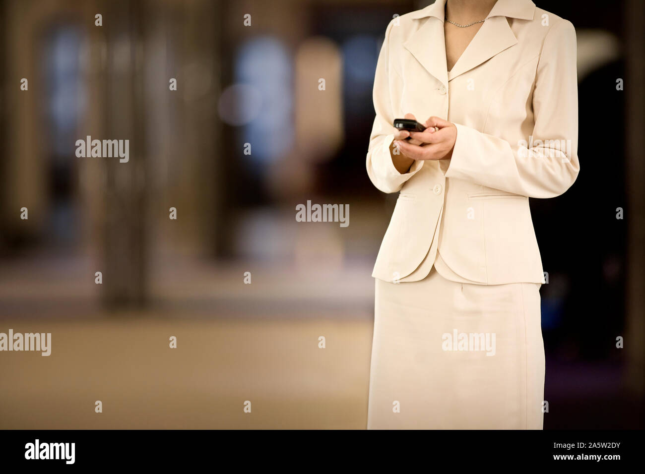 Cellphone being used by a young adult business woman in an office Stock ...