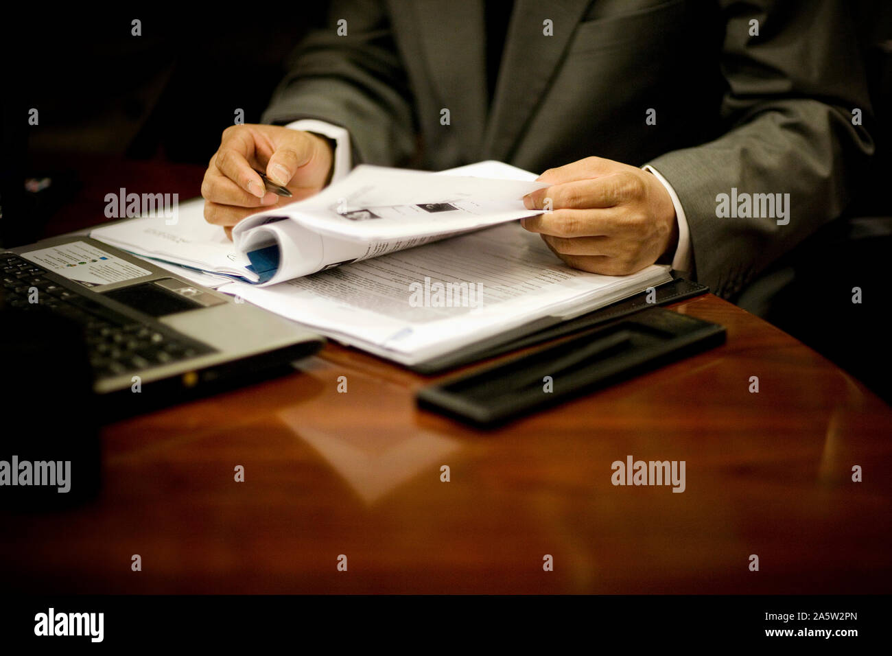 Documents being looked at by a businessman in a boardroom Stock Photo ...