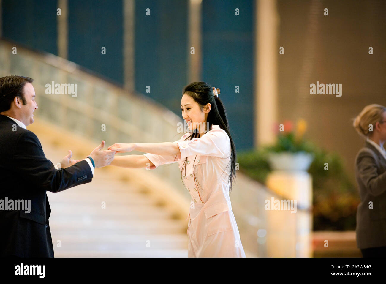 Young adult couple dancing in a hotel lobby Stock Photo - Alamy