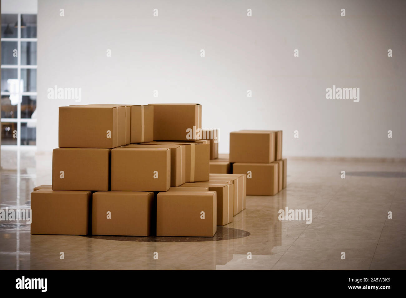 Boxes laying in a lobby Stock Photo - Alamy