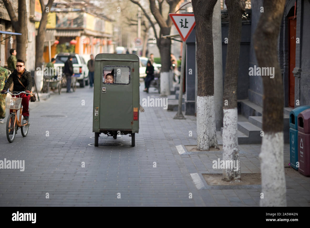 Small boy looking out the back window of a van Stock Photo - Alamy