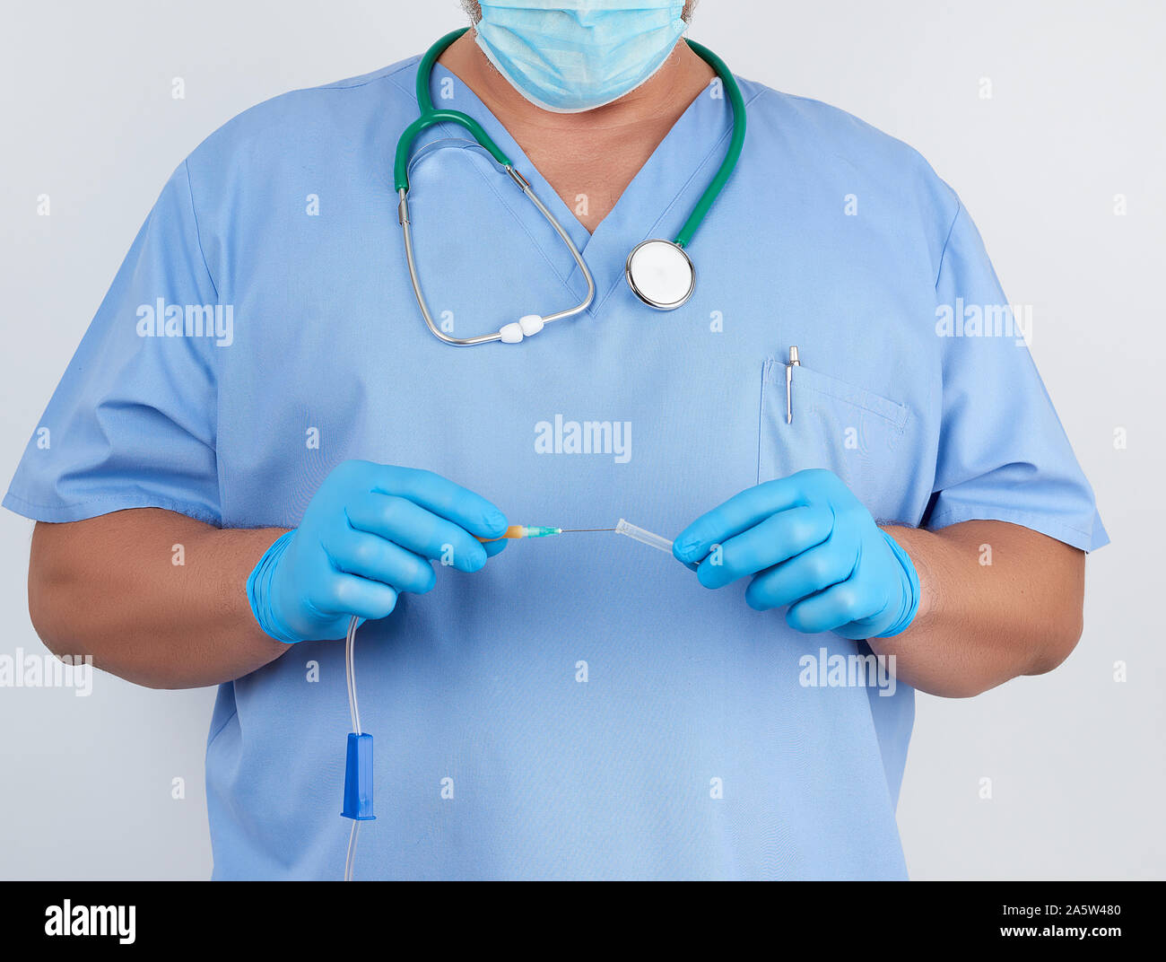 doctor in blue uniform and latex gloves holds a plastic system for ...