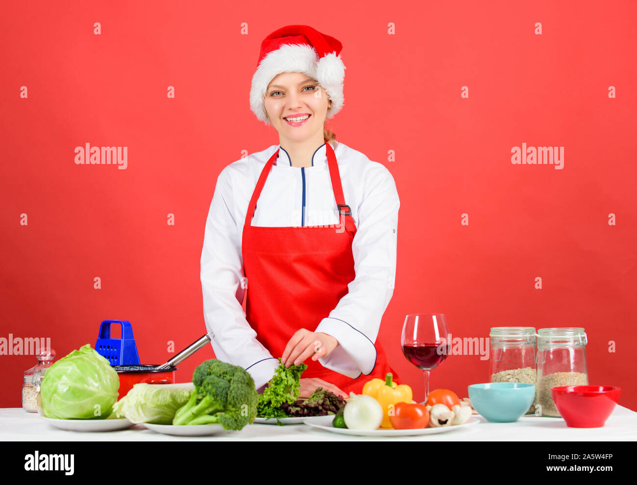 Woman chef cooking christmas dinner wear santa hat. Festive menu ...