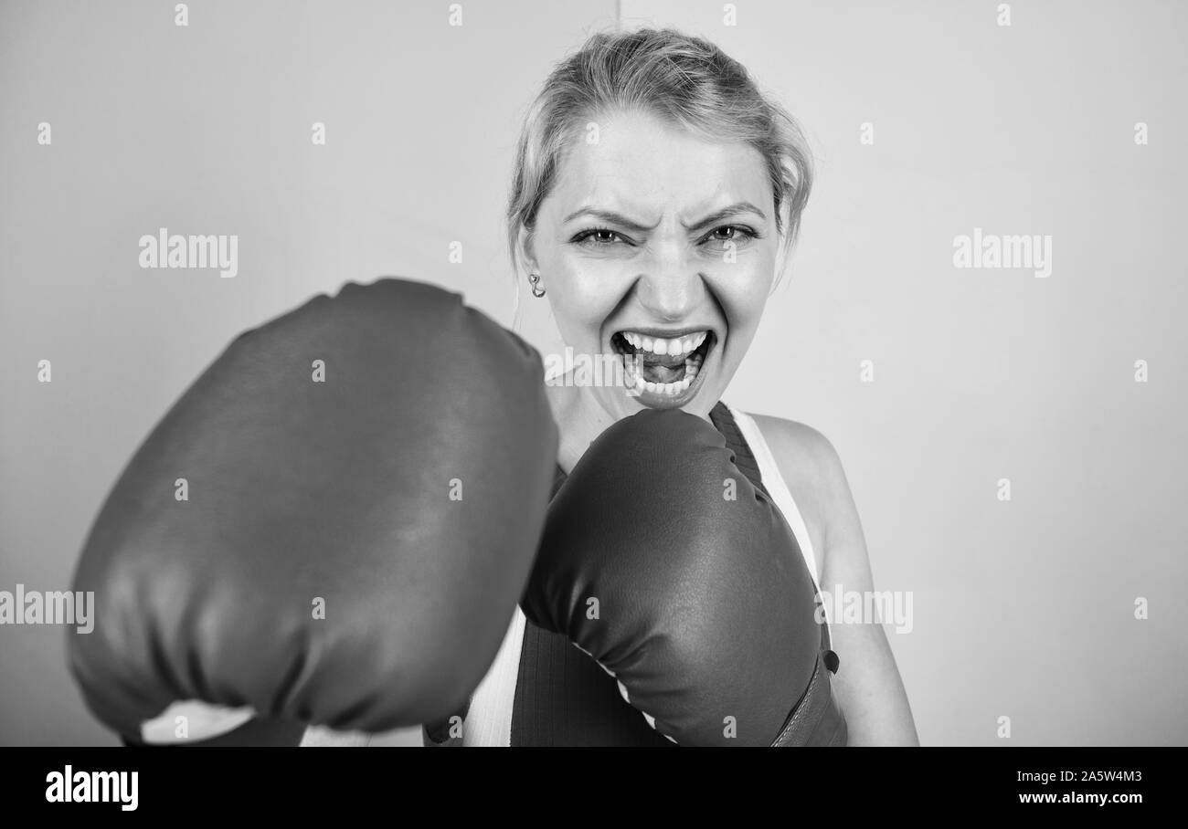 Boxing improve temper and will. Woman boxing gloves focused on attack ...