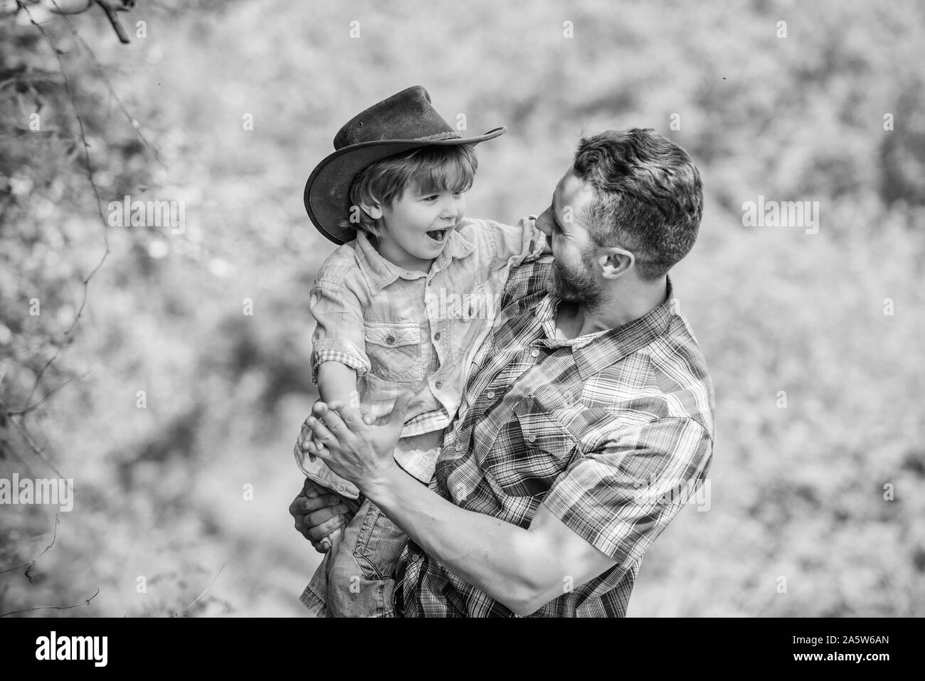 Rustic family. Growing cute cowboy. Small helper in garden. Little boy ...
