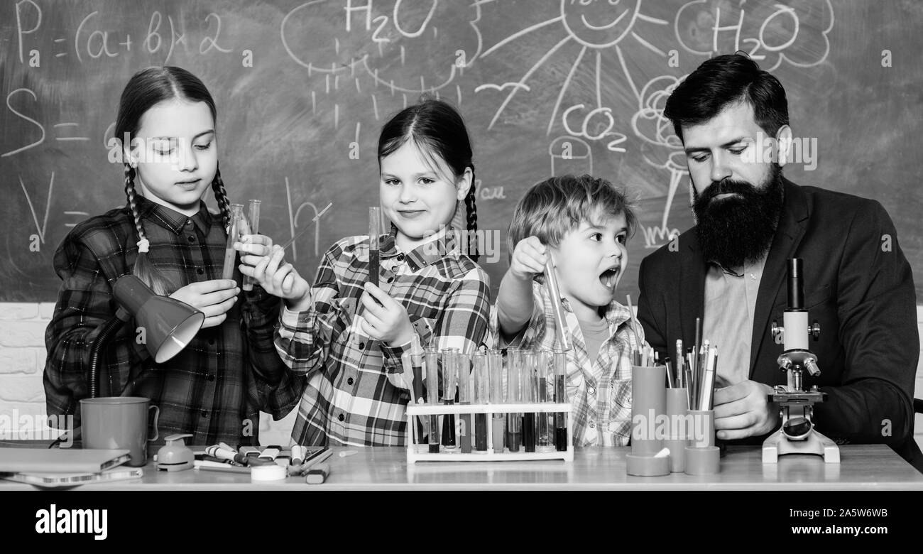Little kids learning chemistry in school laboratory. school kids ...