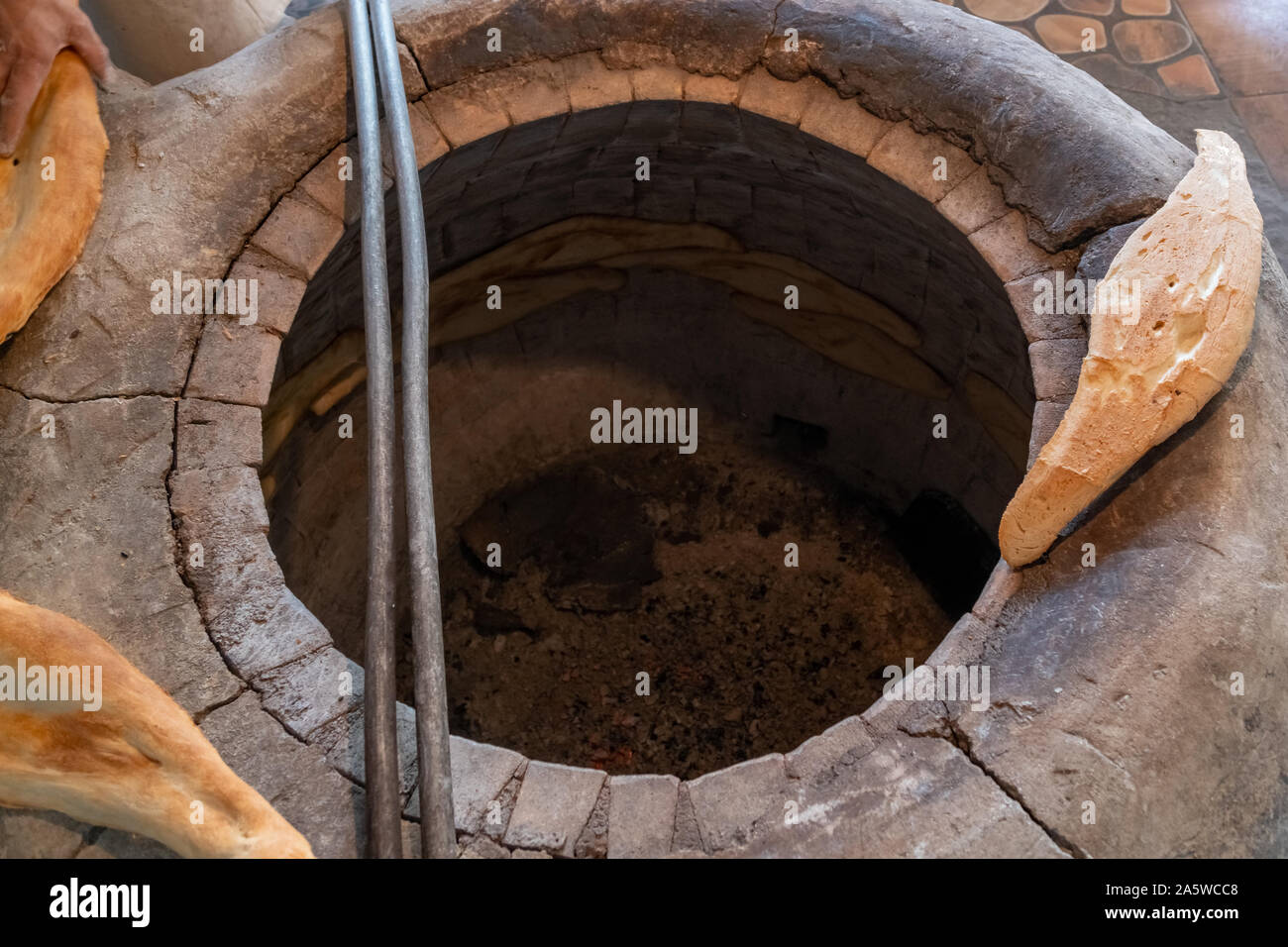Georgian traditional brick oven. Traditional georgian breads. Cooking ...