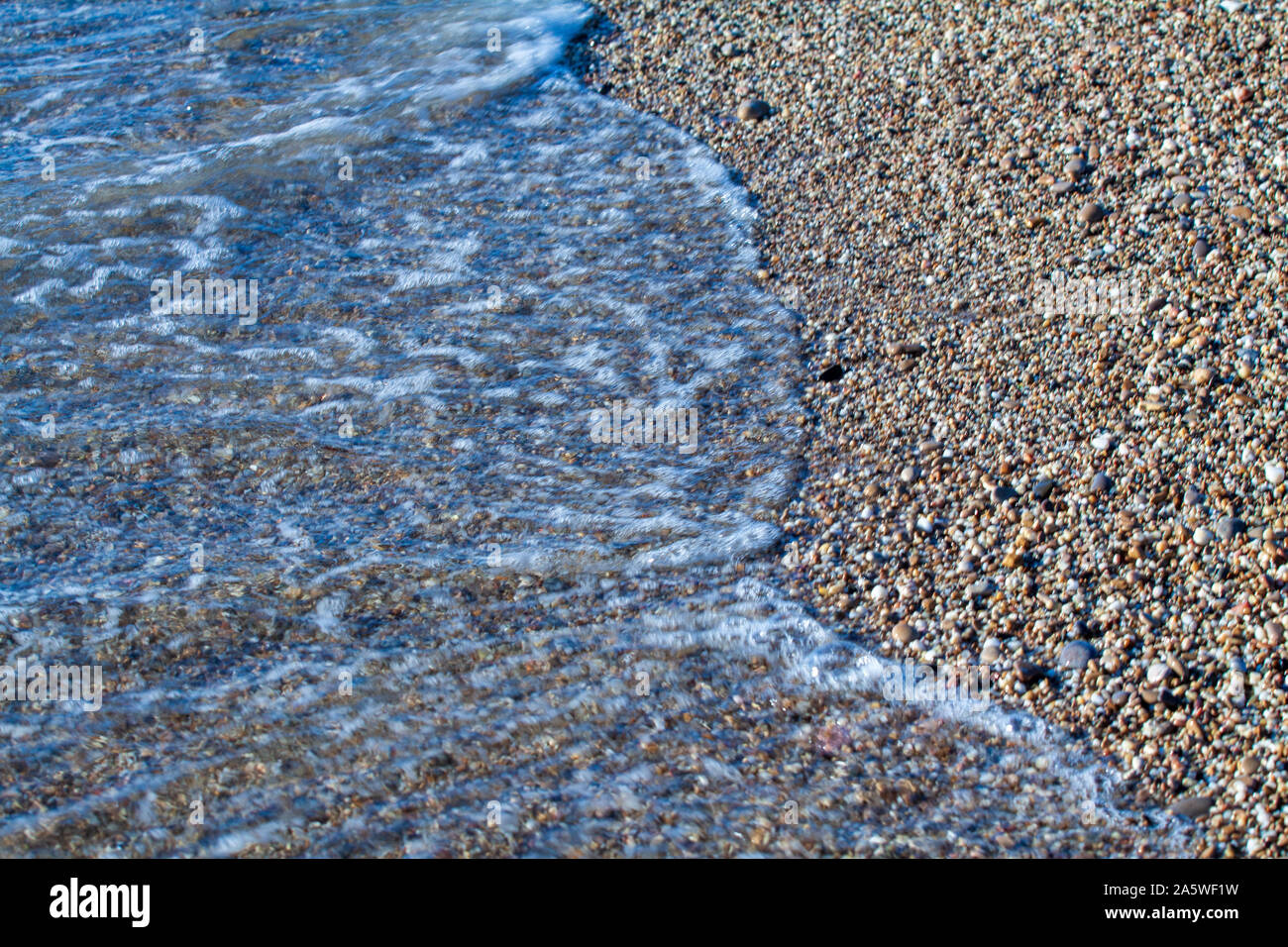 sea pebbles colored granite on the beach background stones. The shore ...