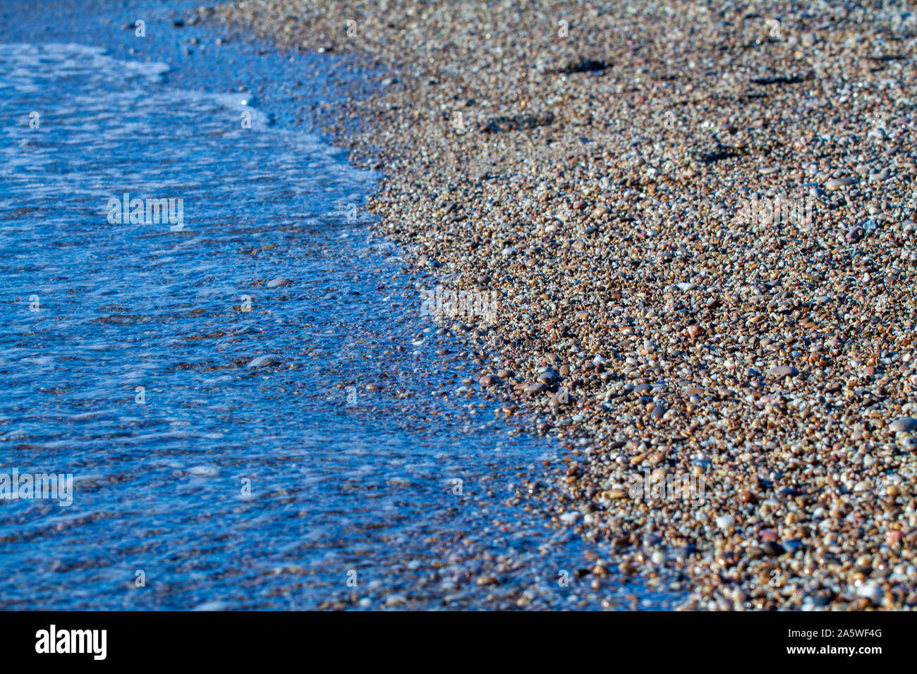 sea pebbles colored granite on the beach background stones. The shore ...