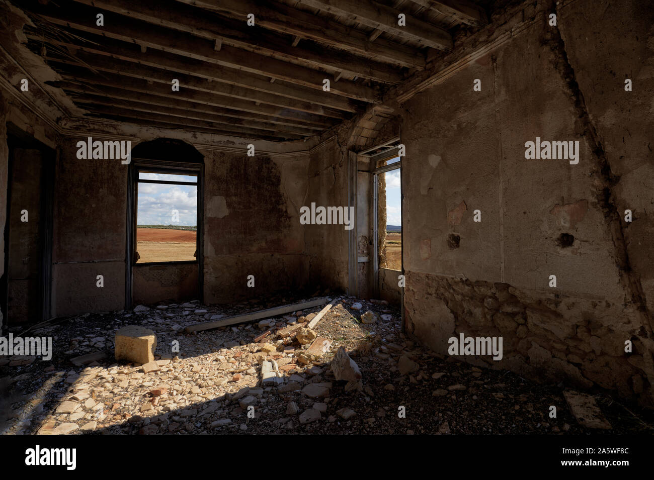 Old room with debris, broken windows and fissured wall Stock Photo - Alamy