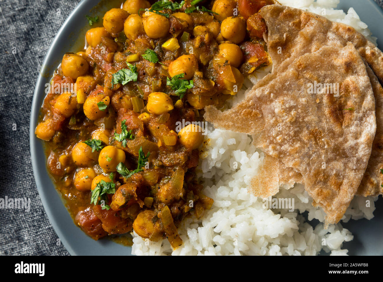 Homemade Indian Chickpea Chana Masala with Rice and Roti Stock Photo ...