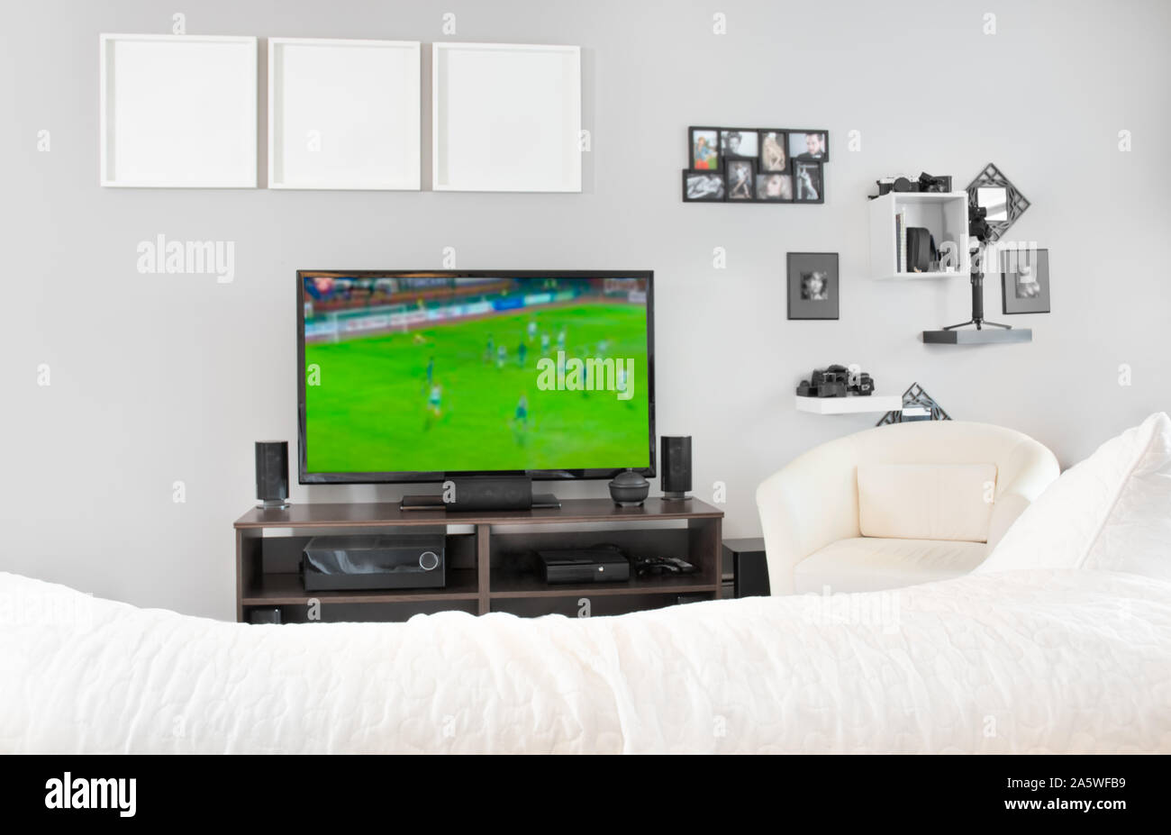 Cozy interior of living room with television, TV watching football ...