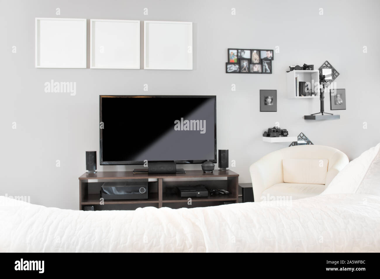 Cozy interior of living room with TV on stand. Blank black television ...