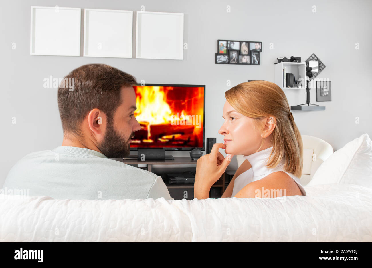 Back view of a happy couple watching tv sitting on couch at home Stock ...