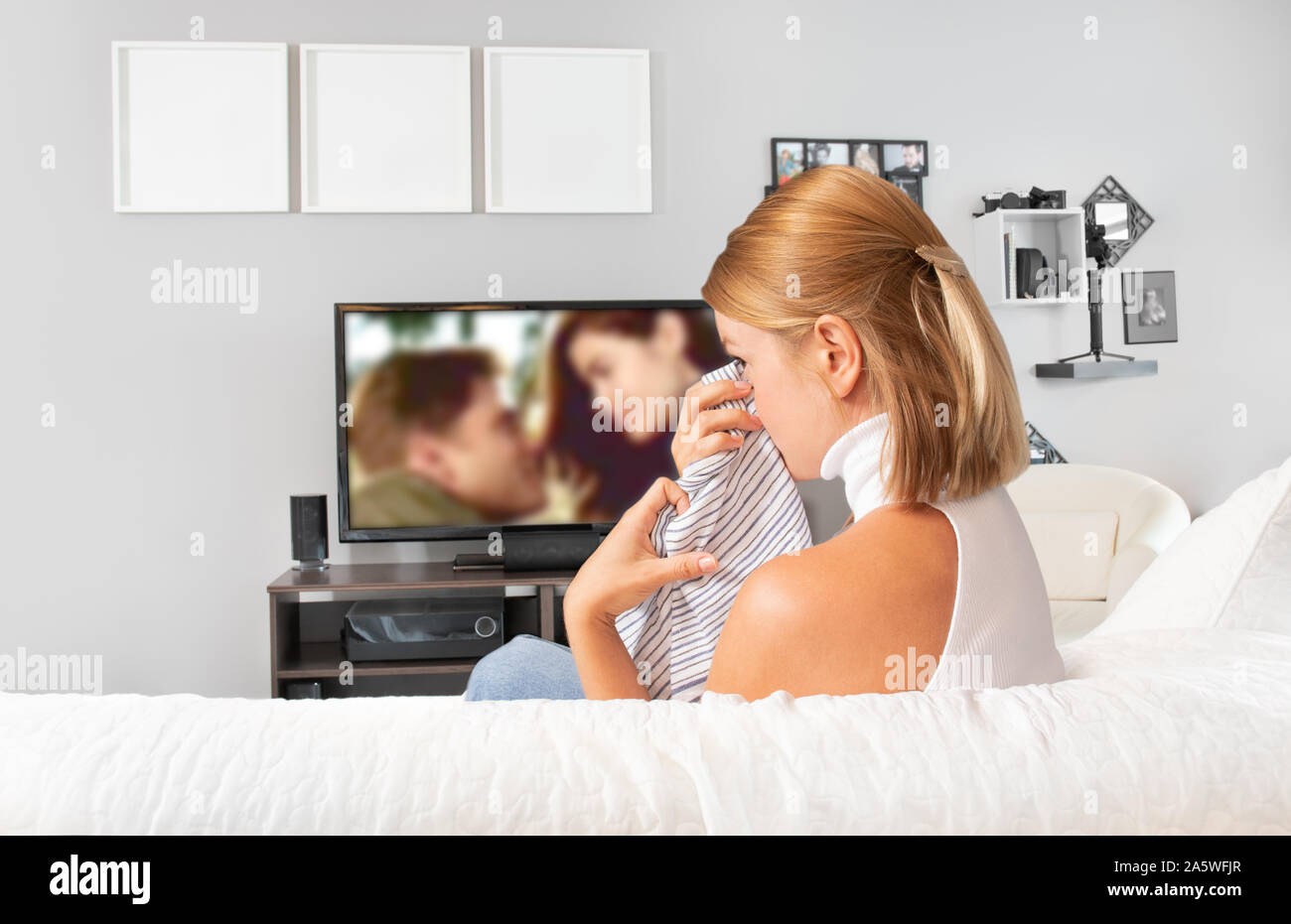 Young woman cry while watching a touching movie Stock Photo - Alamy