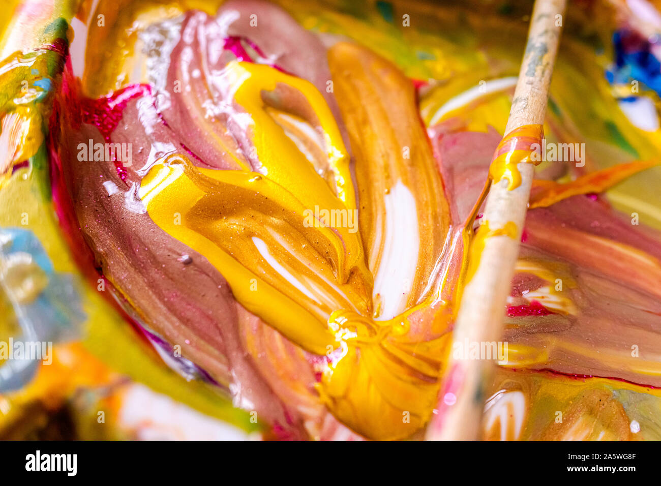 Detail of the mixed colored paintings on the palette of an artist ...