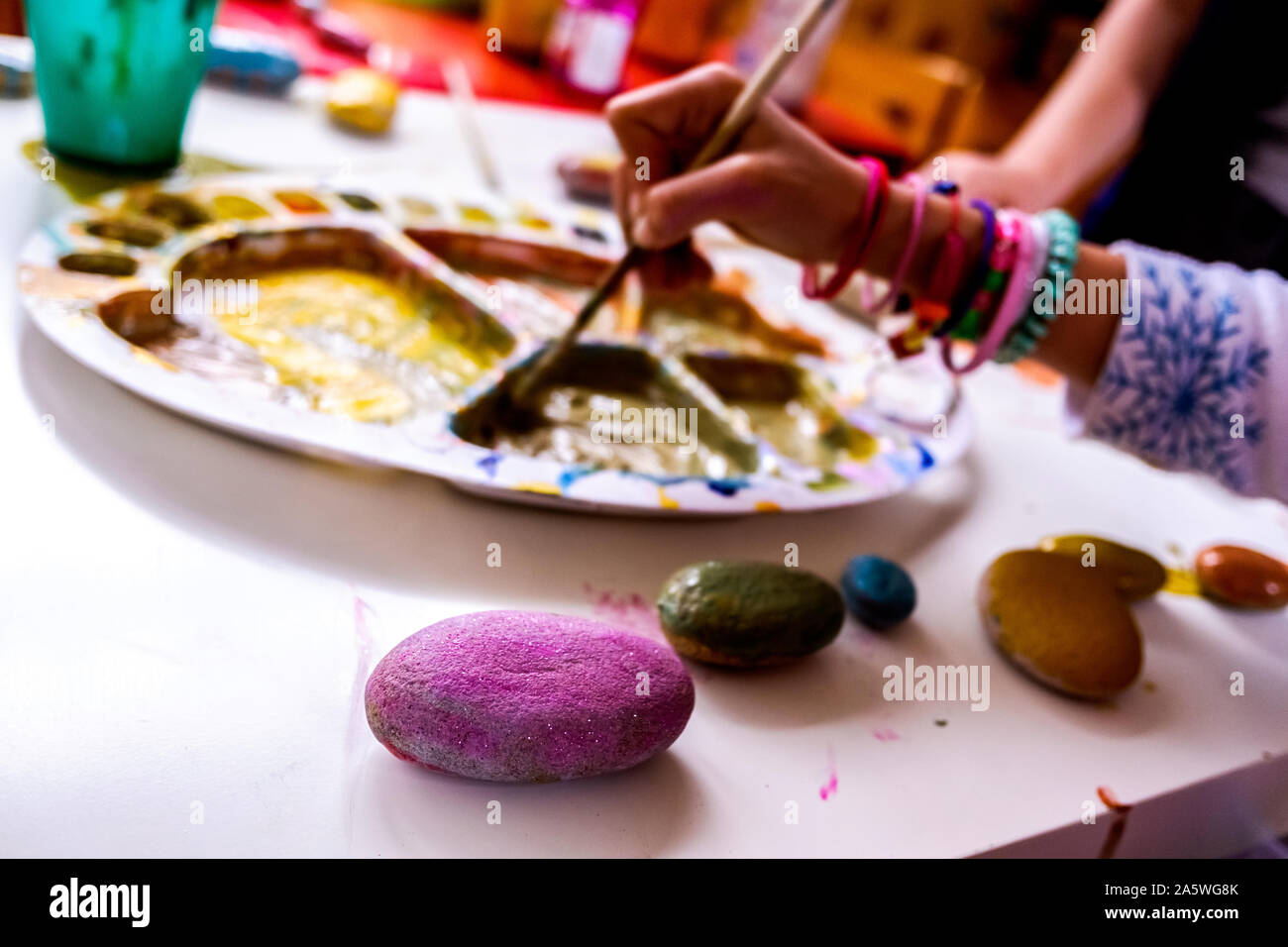 Girl painting with acrylic paint developing her creativity in an art ...