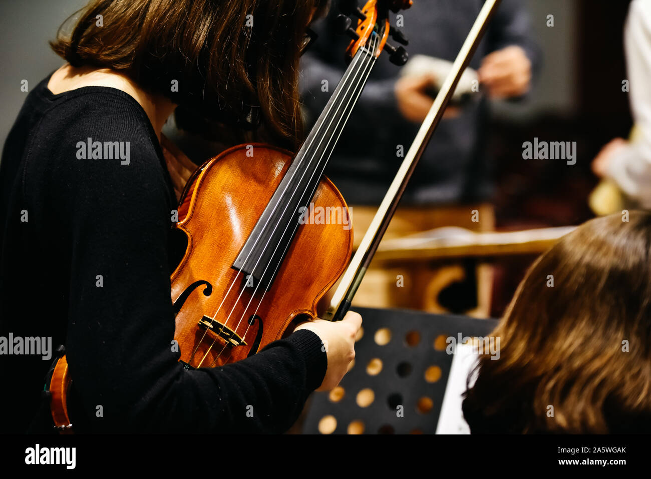 Woman fiddler during a concert, background in black Stock Photo - Alamy