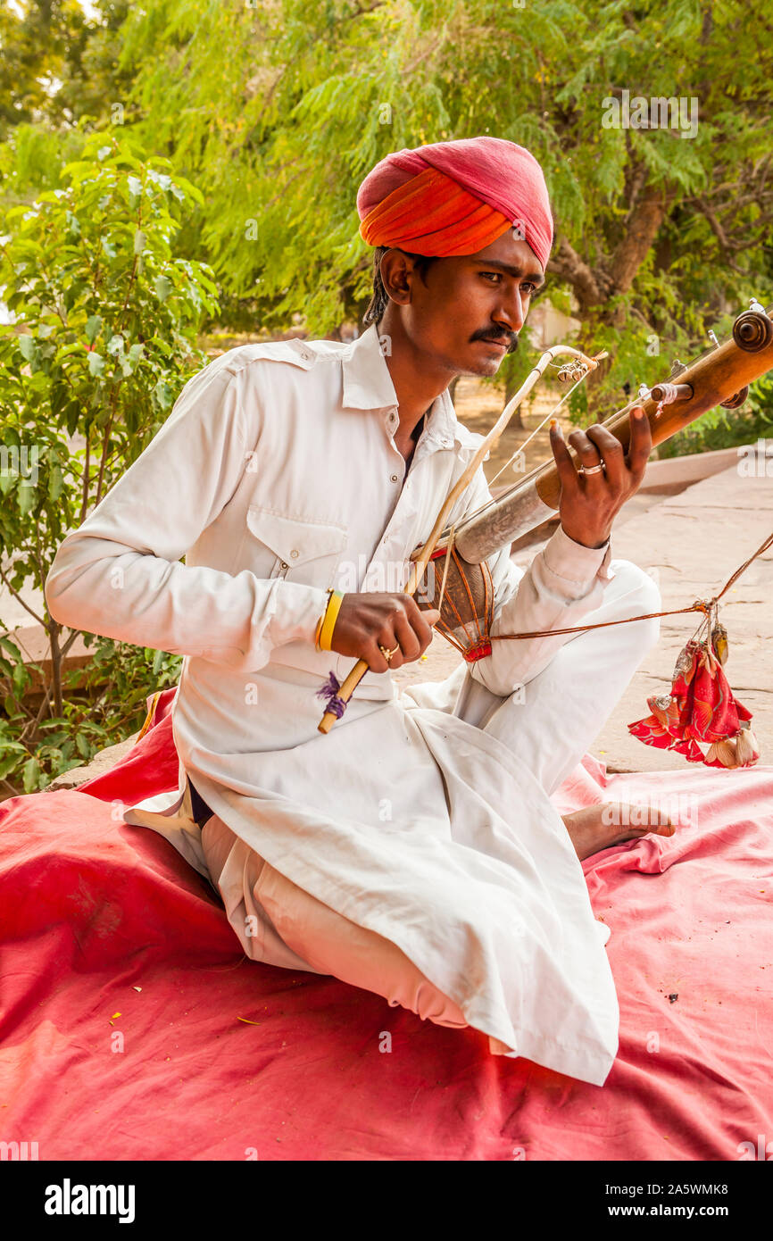 A man playing a traditional instrument called an erhu in Jodhpur ...