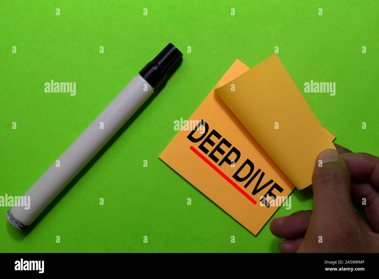 Deep Dive write on sticky notes. Isolated on green table background ...