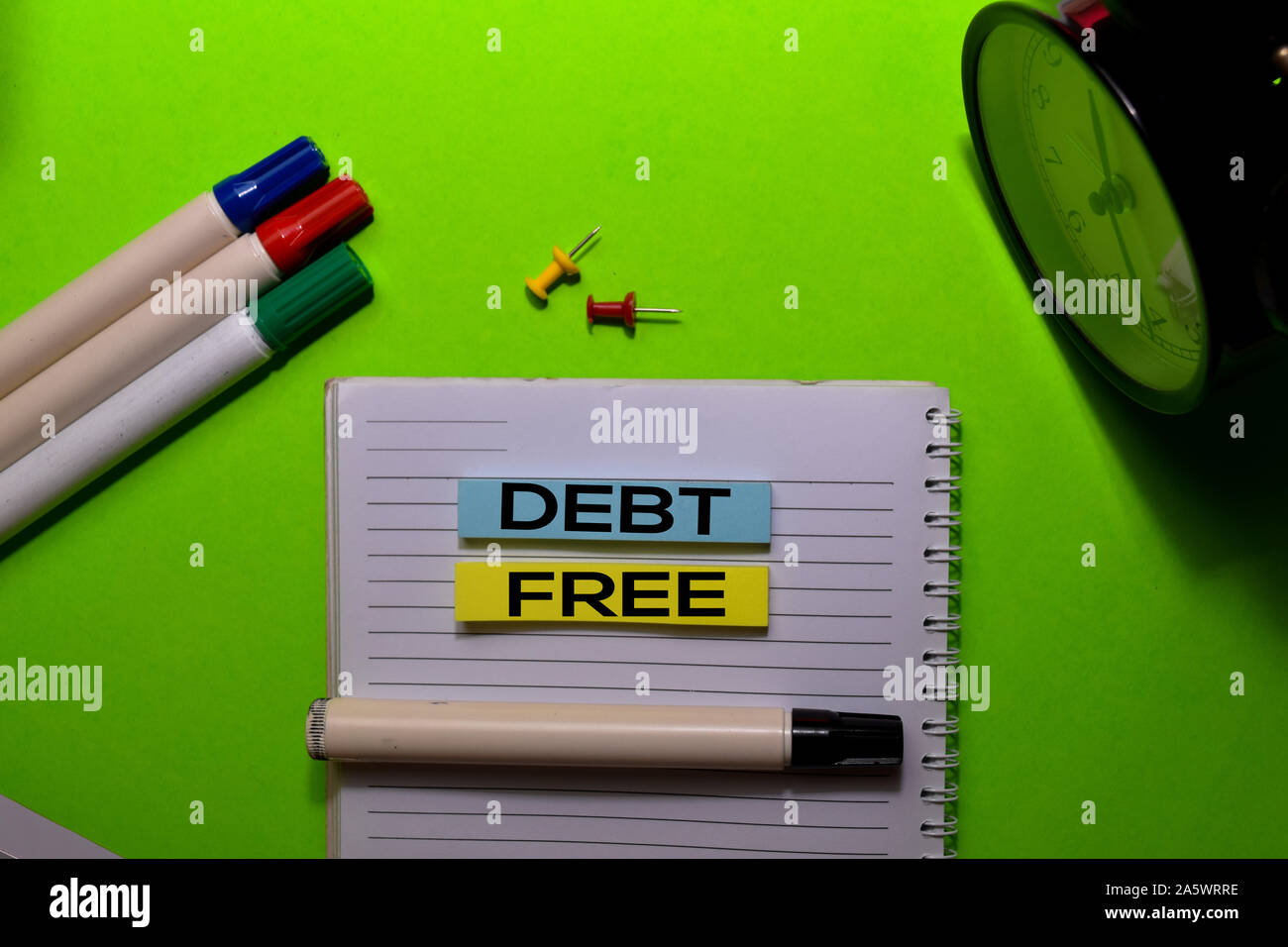 Debt Free write on sticky notes. Isolated on green table background ...