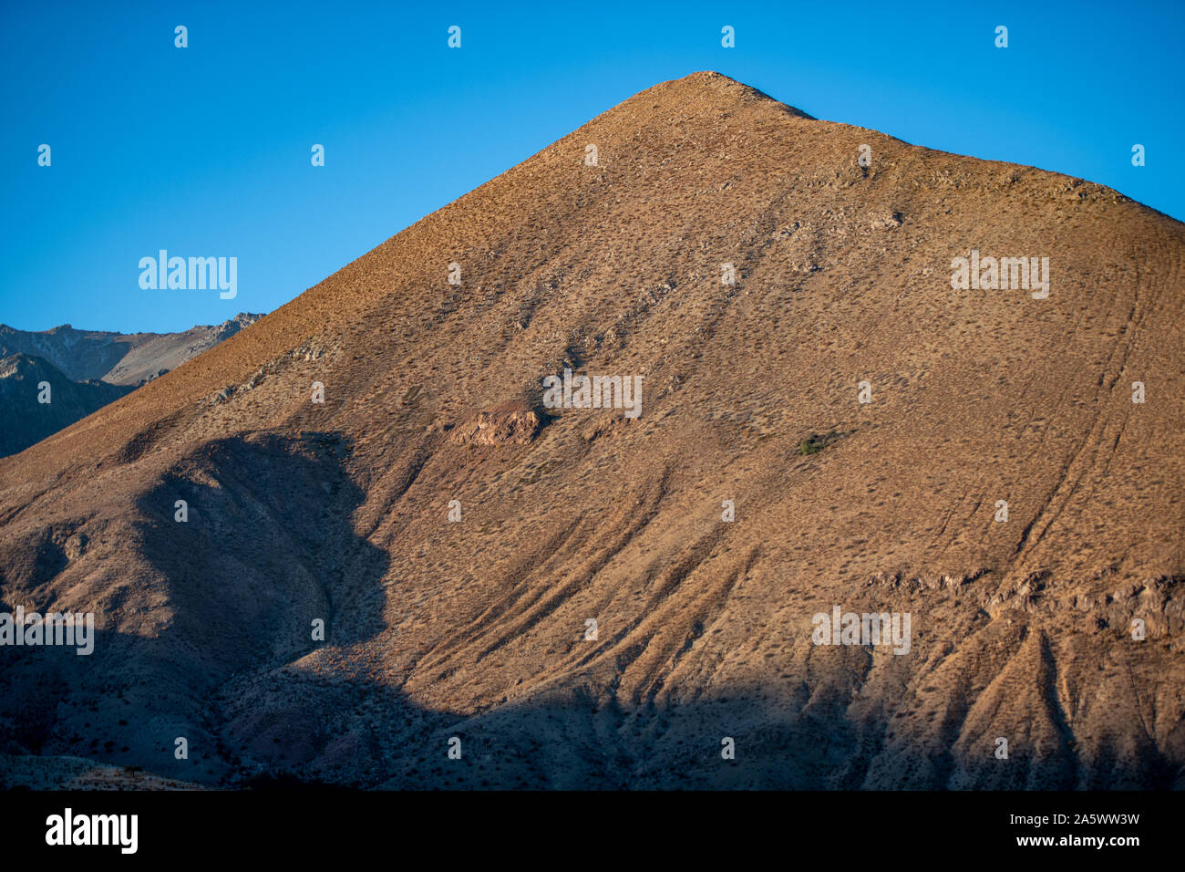 A mountain casts a shadow in the shape of a human head onto another ...