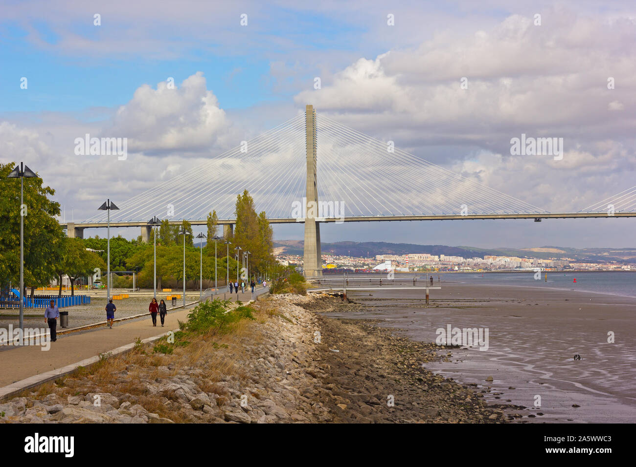 Vasco da Gama bridge and pedestrian walkway along Tagus River with the ...