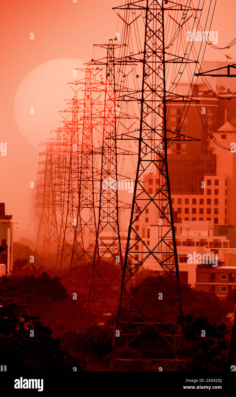 Sun, high voltage electricity towers, buildings, plants, in the modern ...