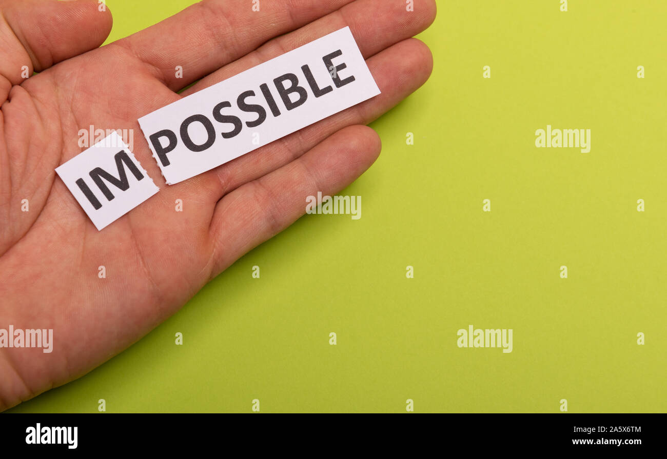 Impossible text cut out in hand. Possible concept. Success. Pink ...