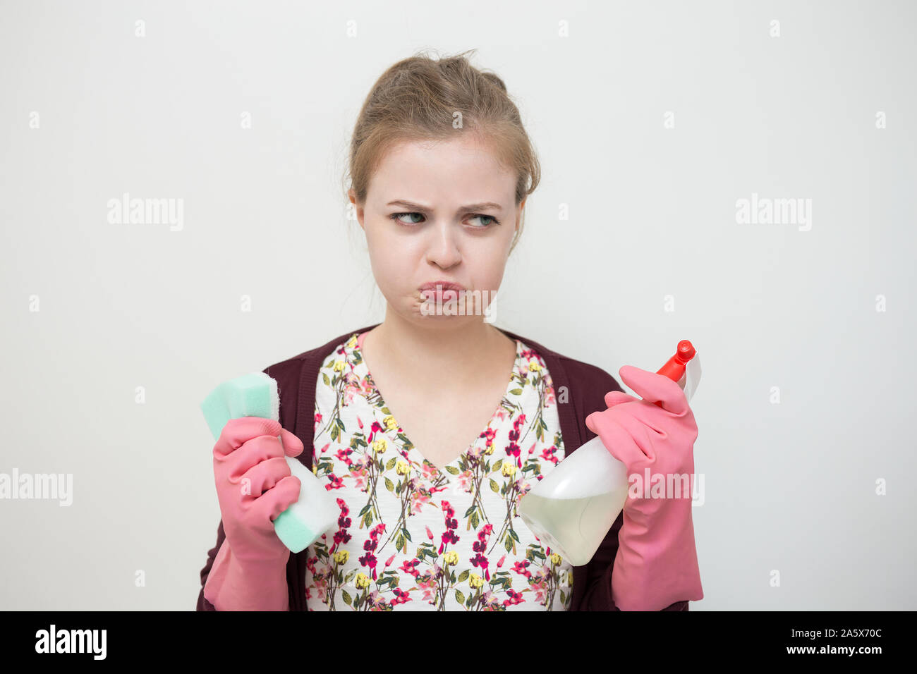 Unhappy sad young caucasian girl woman with rubber gloves, sponge and ...