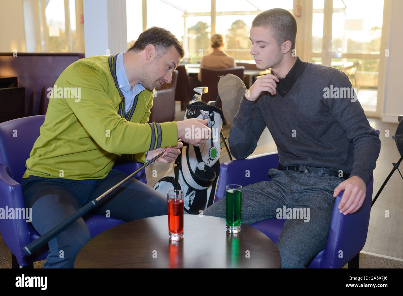 two male golfers in bar Stock Photo - Alamy
