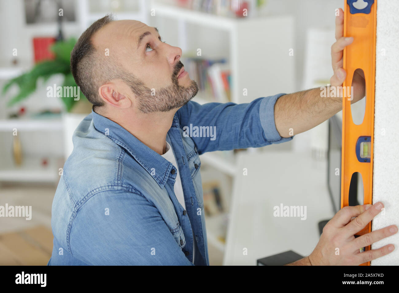 Person measuring marking on wall hi-res stock photography and images ...