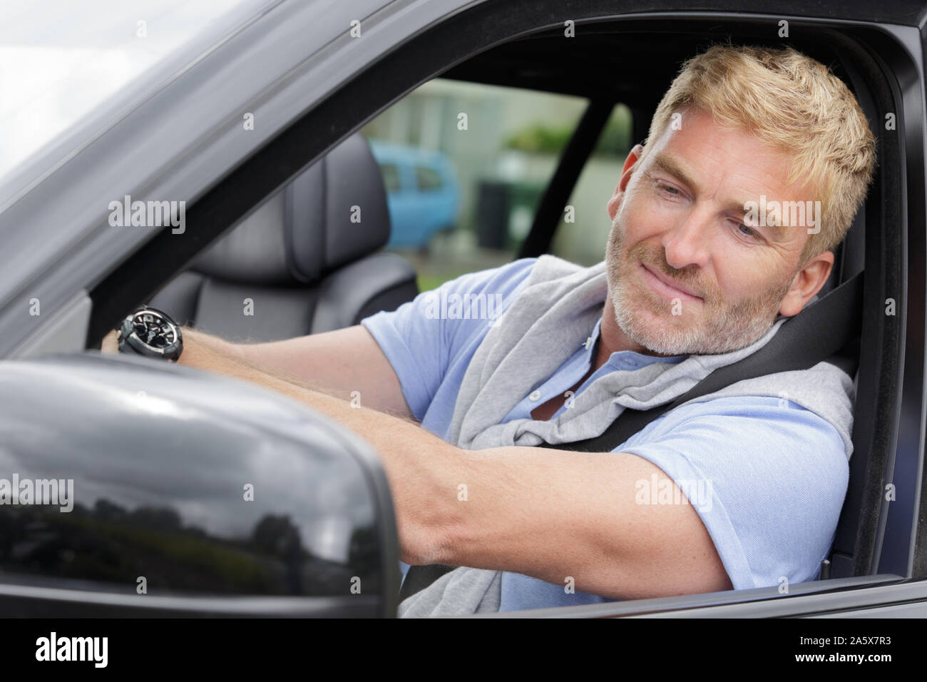 happy smiling man driving his new car Stock Photo - Alamy