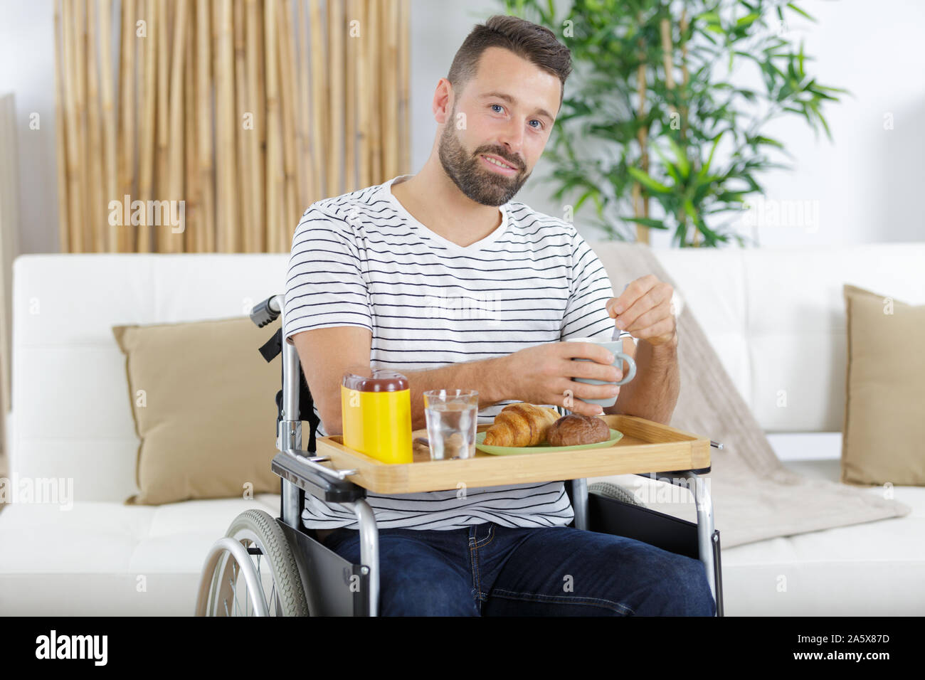 a smiling disabled having breakfast Stock Photo - Alamy