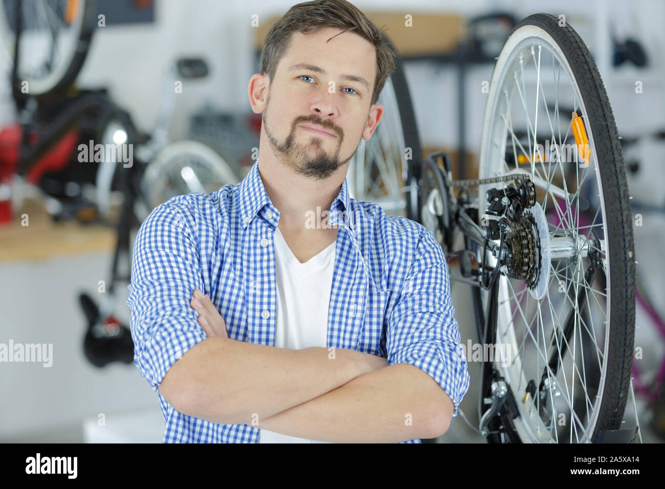 man working in cycle repair shop Stock Photo - Alamy