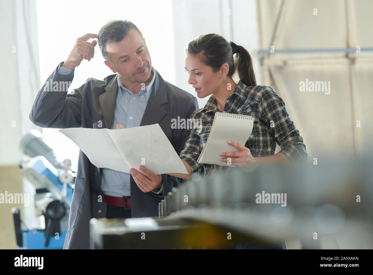 young engineer woman shows her co-worker Stock Photo - Alamy
