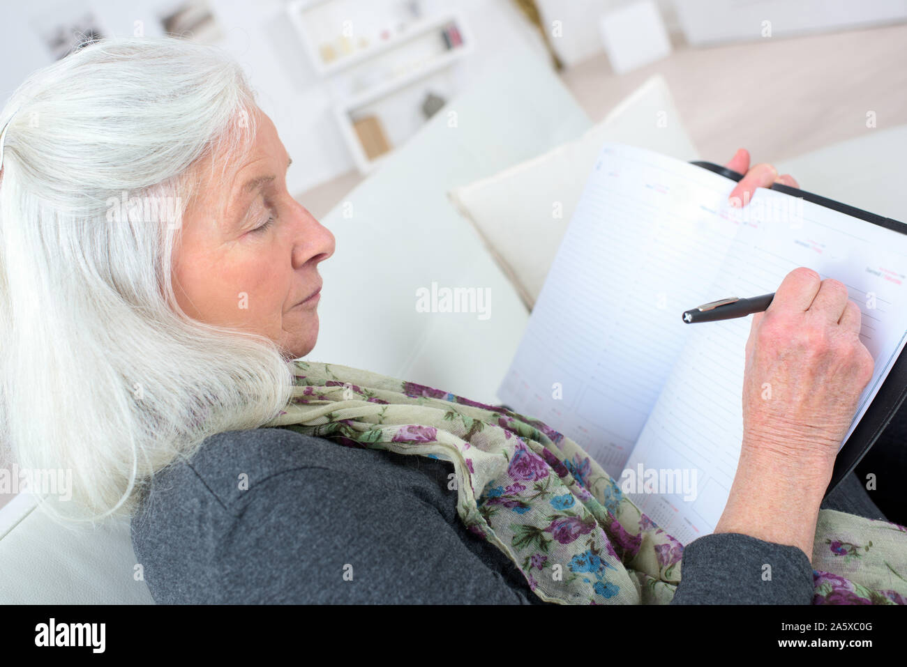 Elderly woman writing hi-res stock photography and images - Alamy