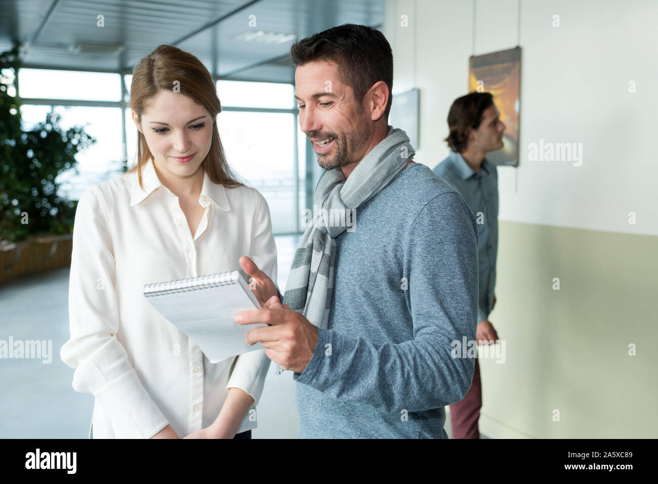 boss and assistant working in a corridor Stock Photo - Alamy