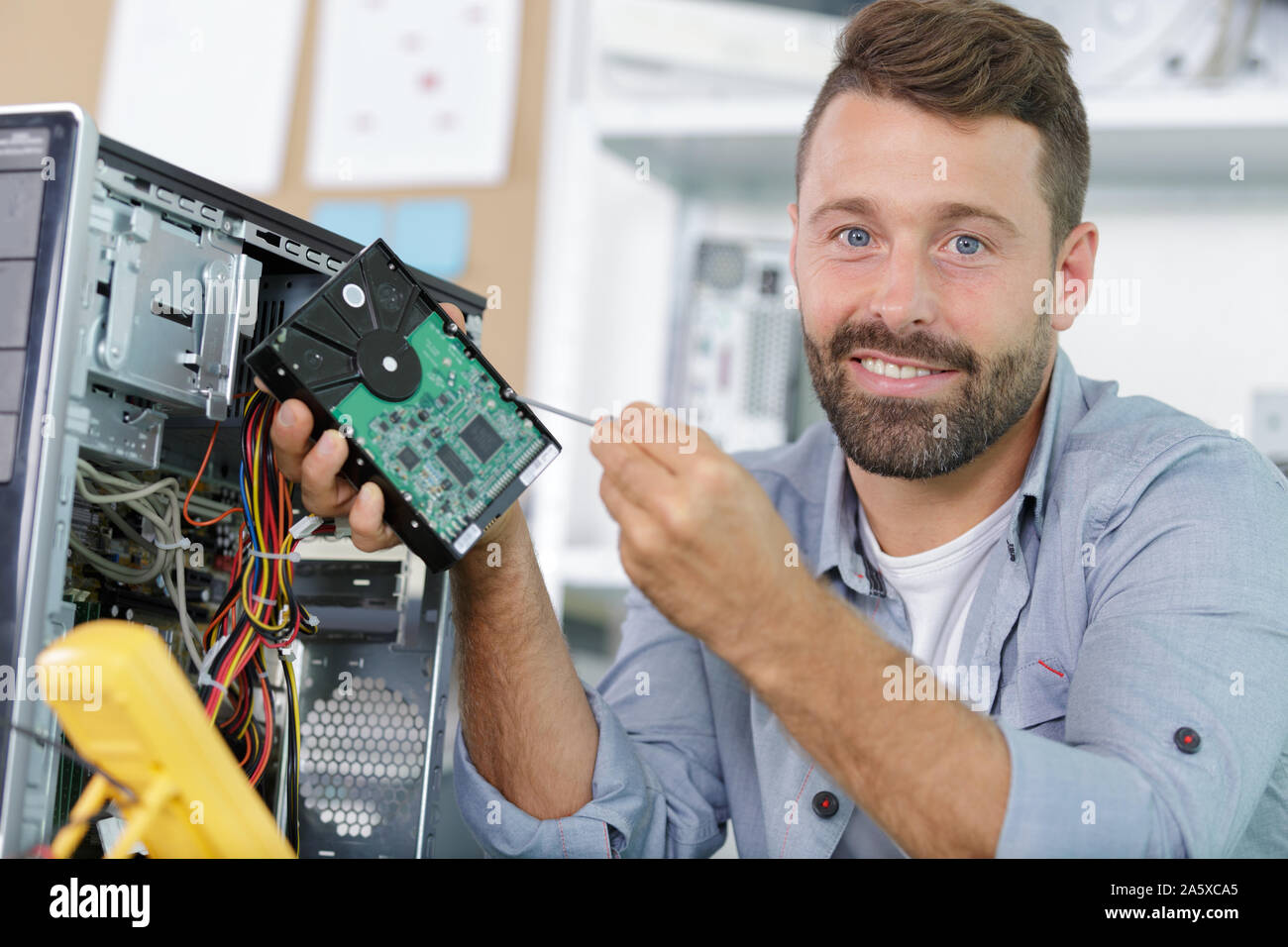 man taking care of a hard drive Stock Photo - Alamy