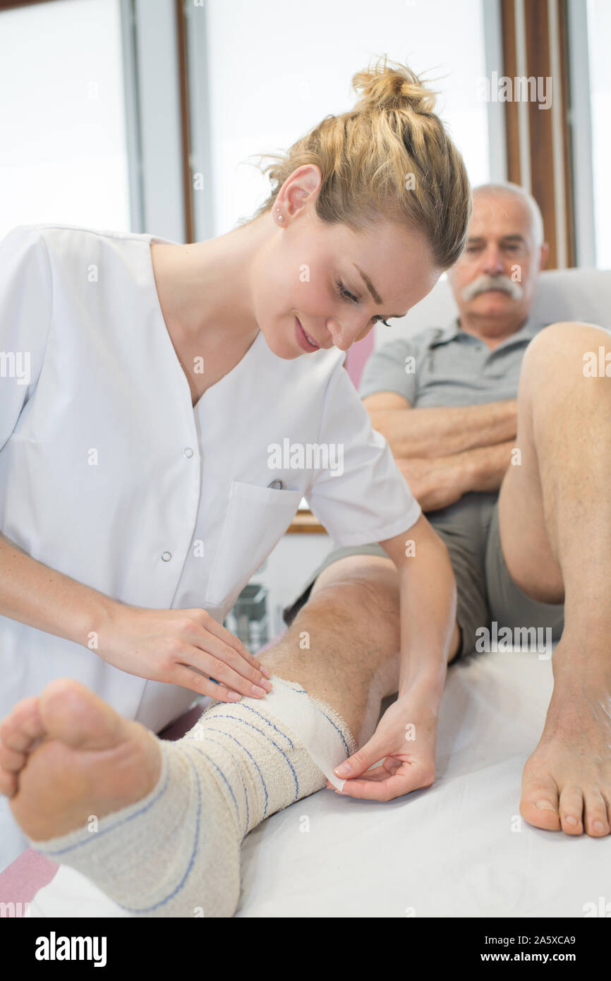 beautiful female medical bandaging senior leg Stock Photo - Alamy