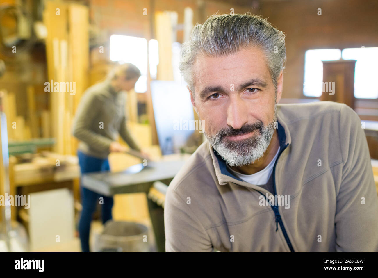 positive carpenter is enjoying time at his job Stock Photo - Alamy