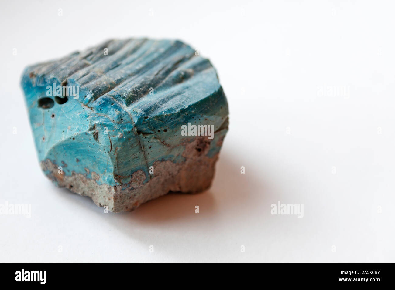 a teal large slag stone lies on white background Stock Photo - Alamy