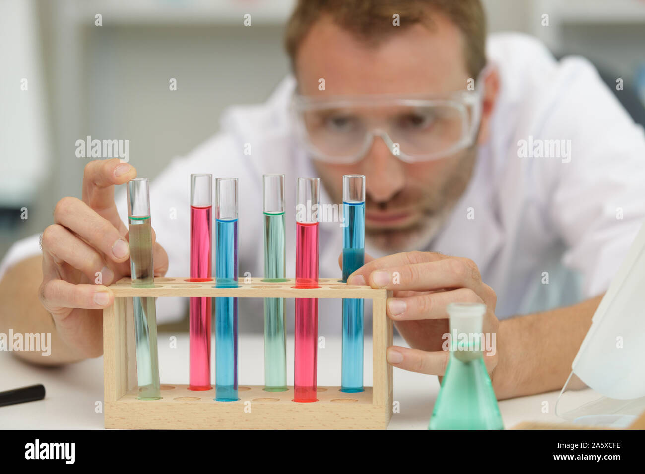 man in laboratory checking test tubes Stock Photo - Alamy