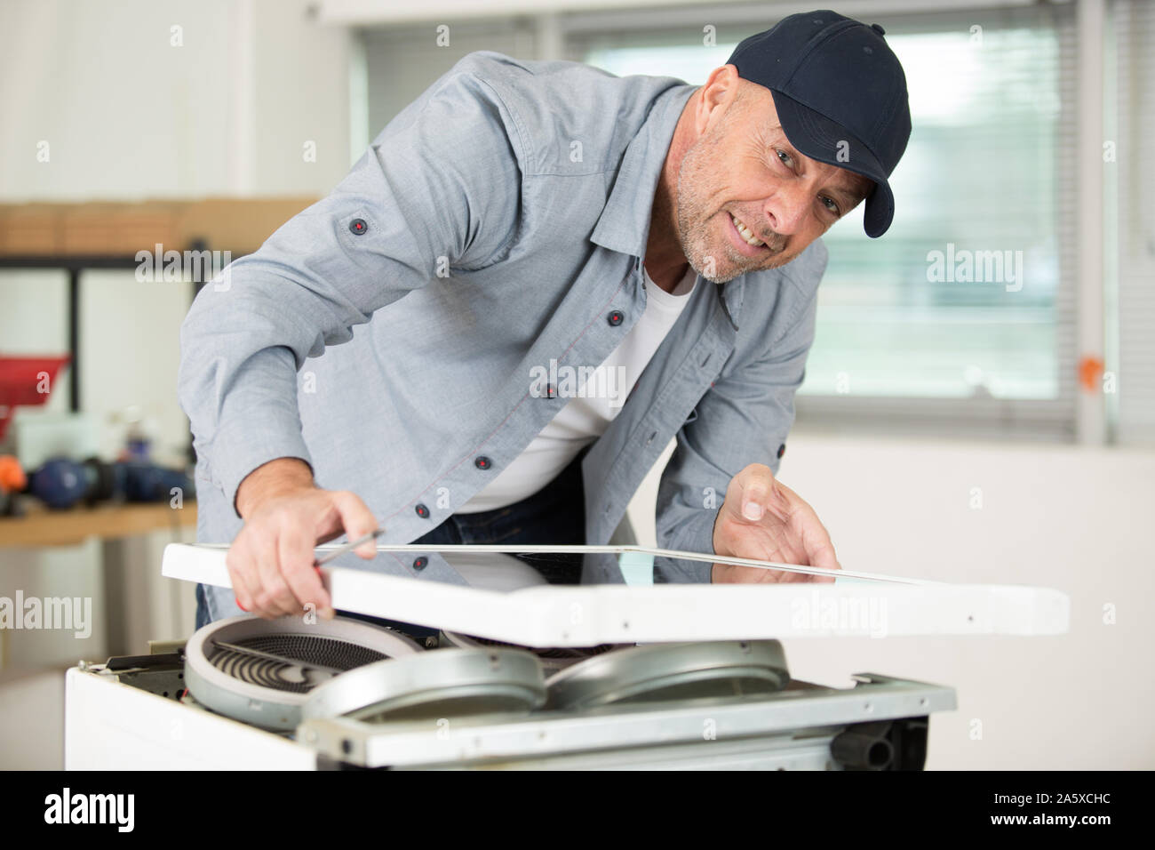 man fixing something in the kitchen Stock Photo - Alamy