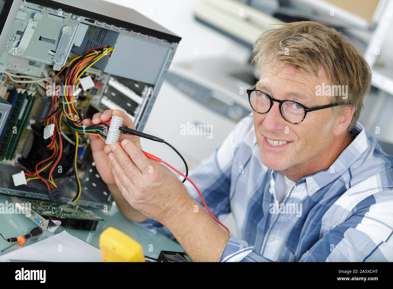 mature computer engineer examining computer Stock Photo - Alamy
